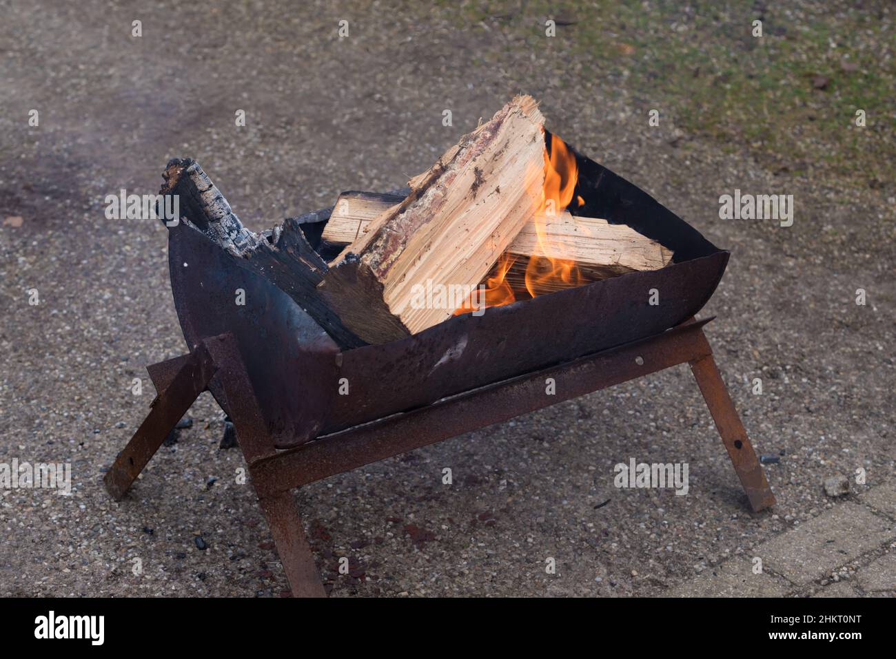 home made fire pit with burning wood Stock Photo - Alamy