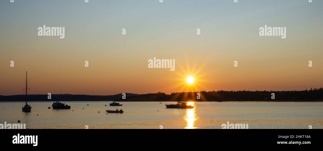Beautiful view of a sea with boats at sunset Stock Photo - Alamy