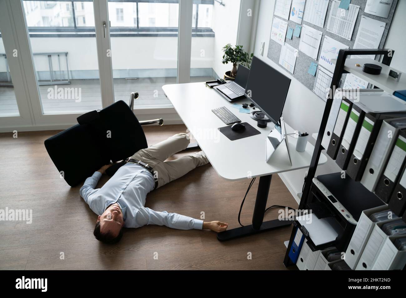 Faint Accident In Office. Fall From Chair At Workplace Stock Photo - Alamy