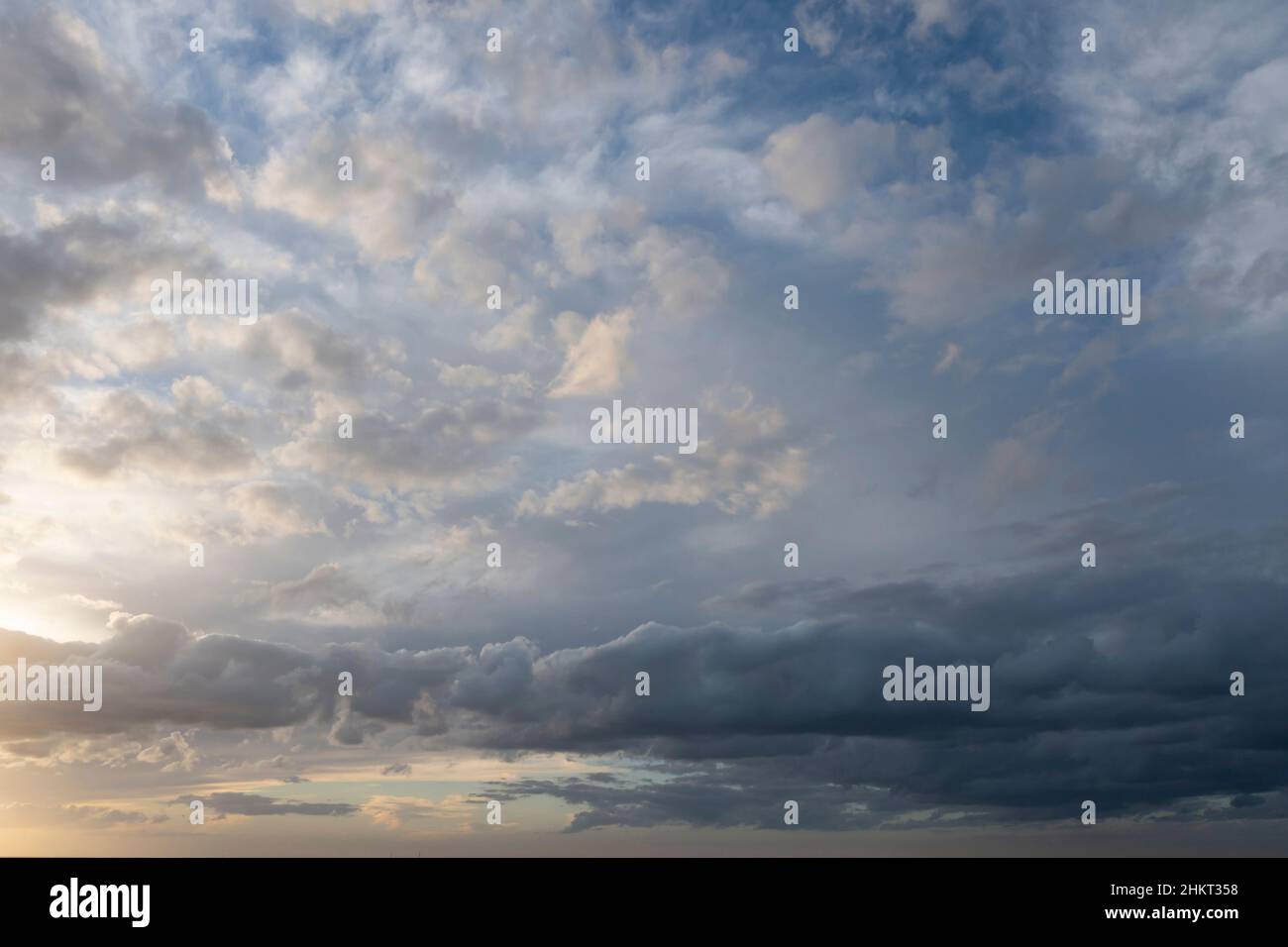 Aerial cloudscape of partly cloudy skies above, sun breaking through ...