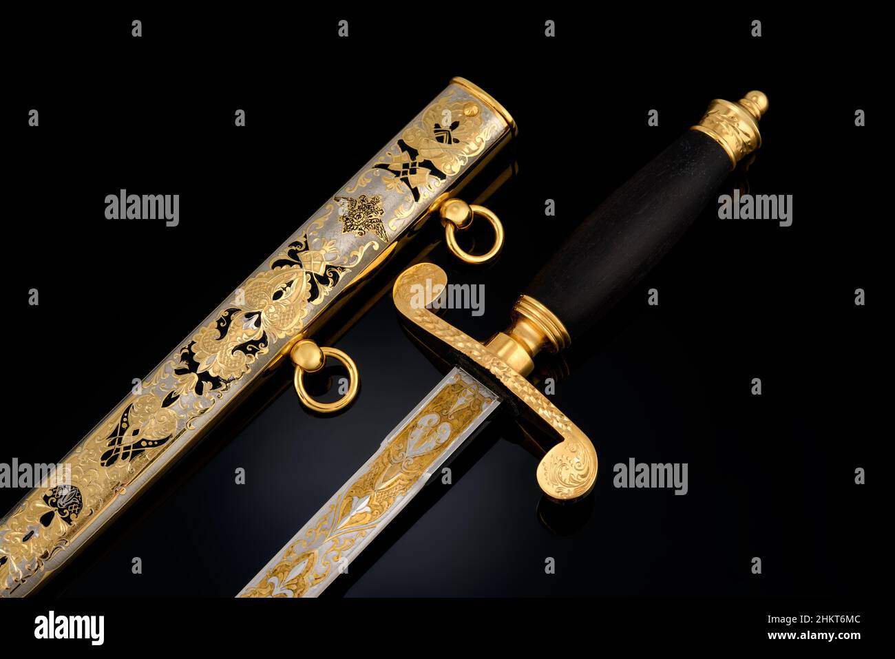 souvenir collectible silver gold dagger with scabbard on black. Luxury ...