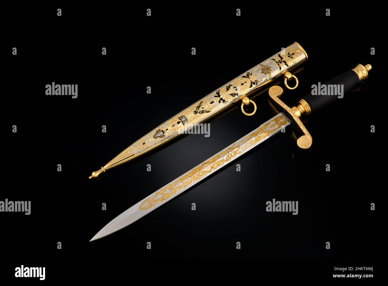 souvenir collectible silver gold dagger with scabbard on black. Luxury ...
