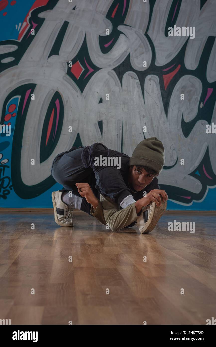 Modern rapper dancing in garage. Urban lifestyle, hip hop Stock Photo ...