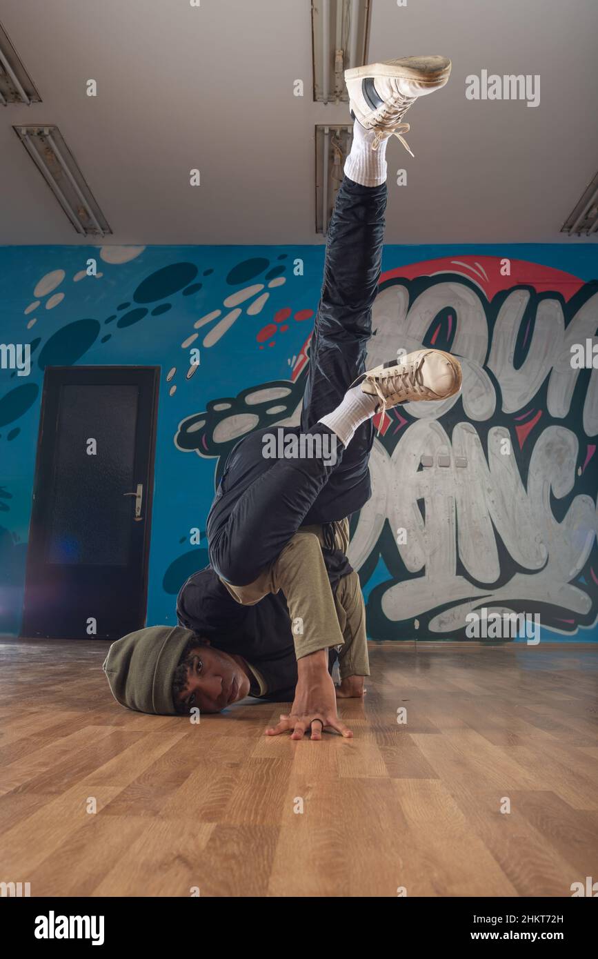 Modern rapper dancing in garage. Urban lifestyle, hip hop Stock Photo ...