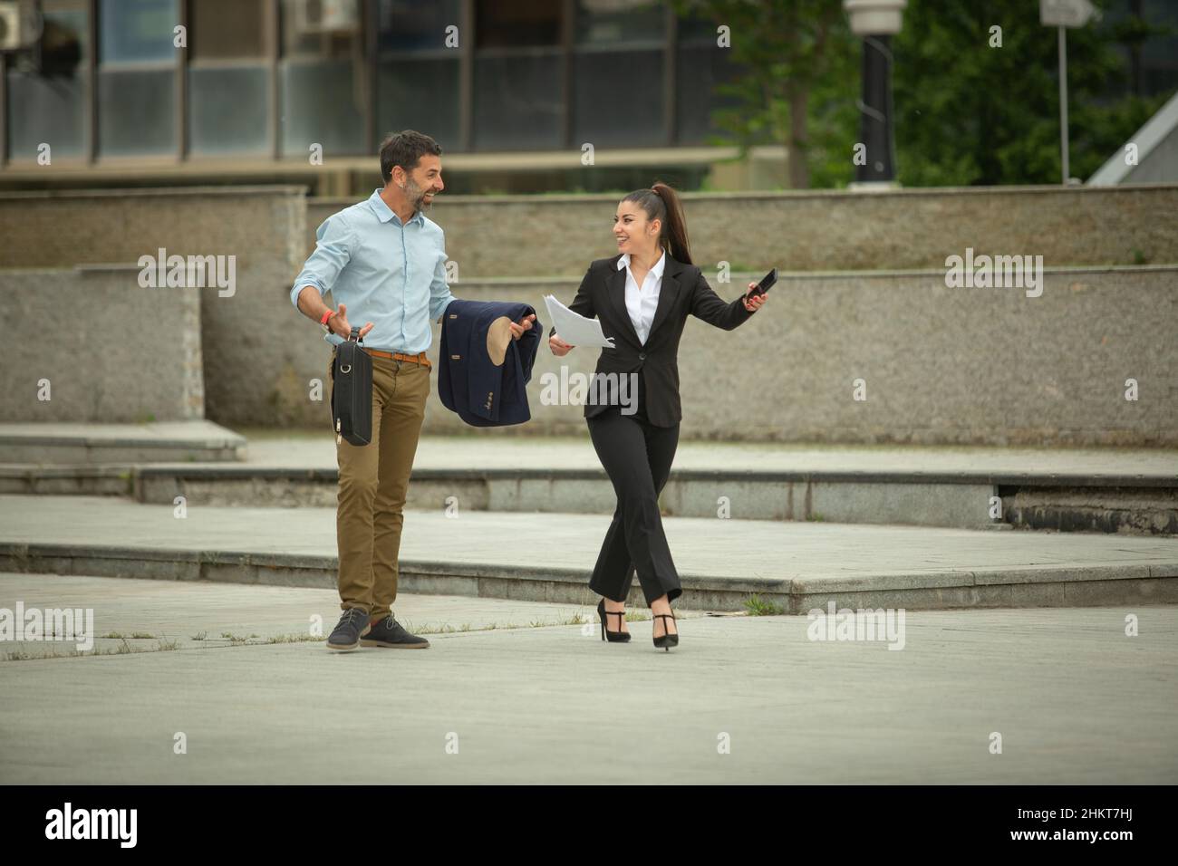 Two italian business partners are walking together while talking about ...