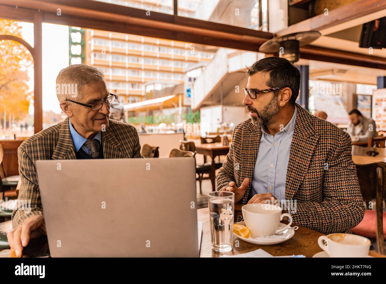 Two senior businessmen are talking on their meeting in the cafe Stock ...