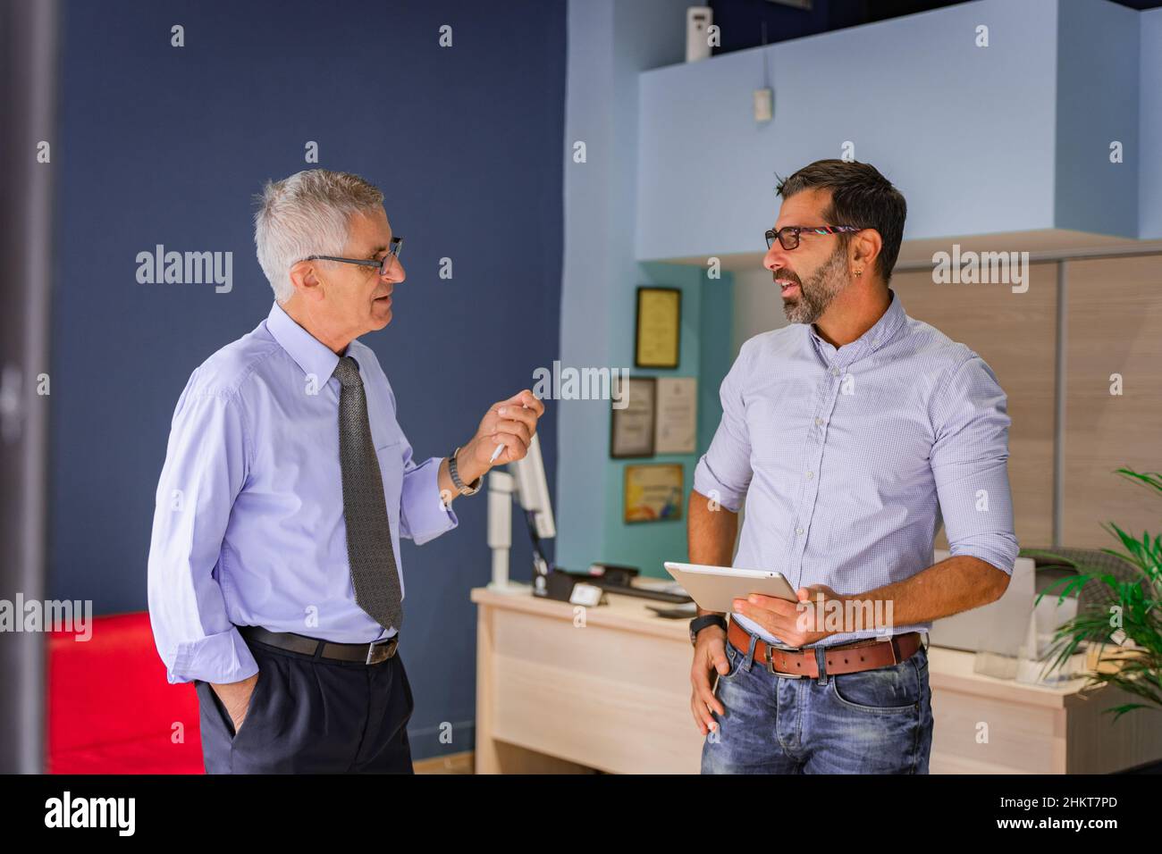 Two senior businessmen are talking about the new plans and ideas for ...