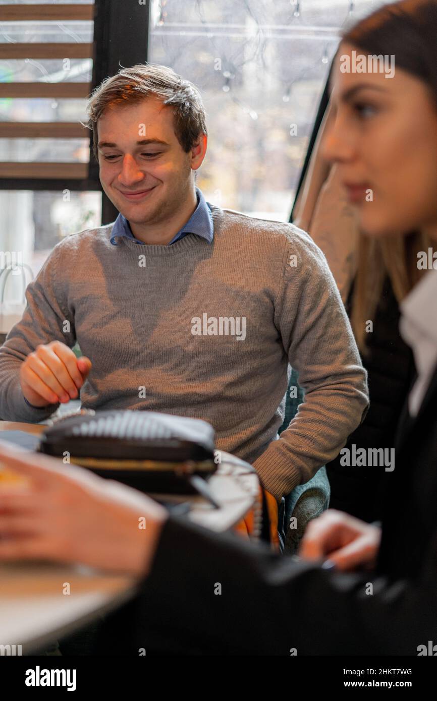Two young and attractive business people are smiling together Stock ...