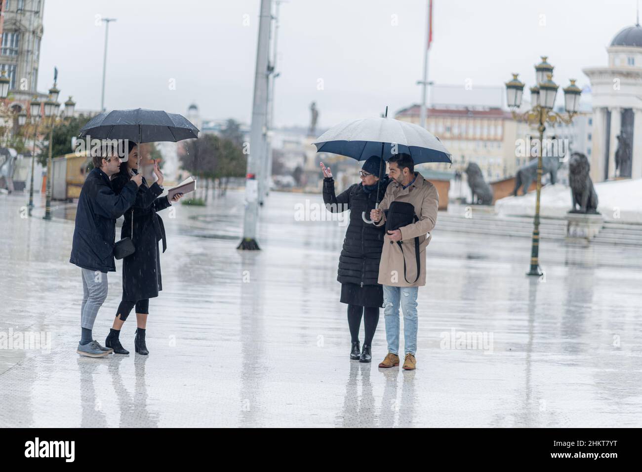 Four amazing business people are standing and talking Stock Photo - Alamy