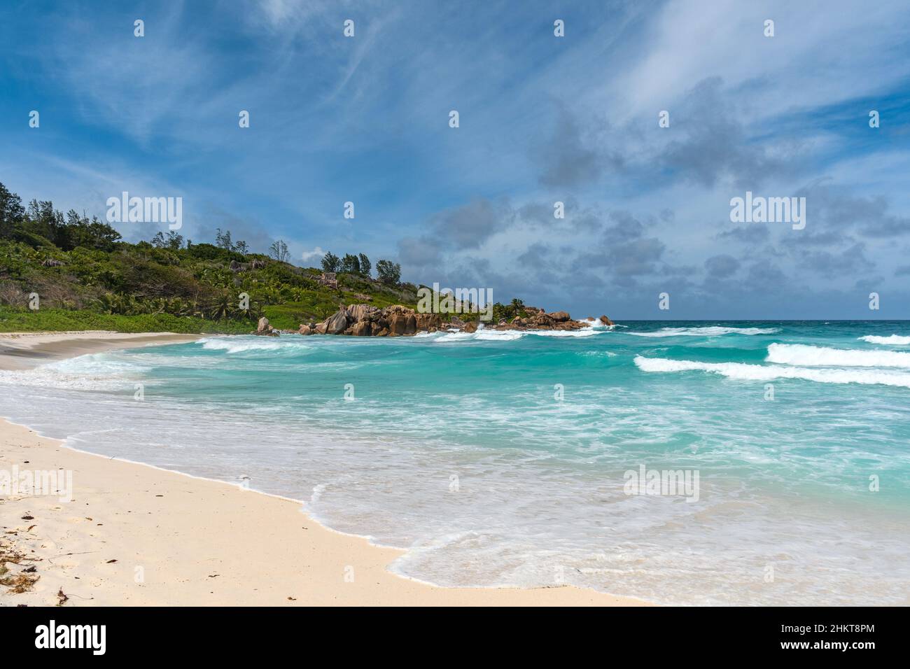 Sandy beach with turquoise sea and waves in the bay on a tropical ...