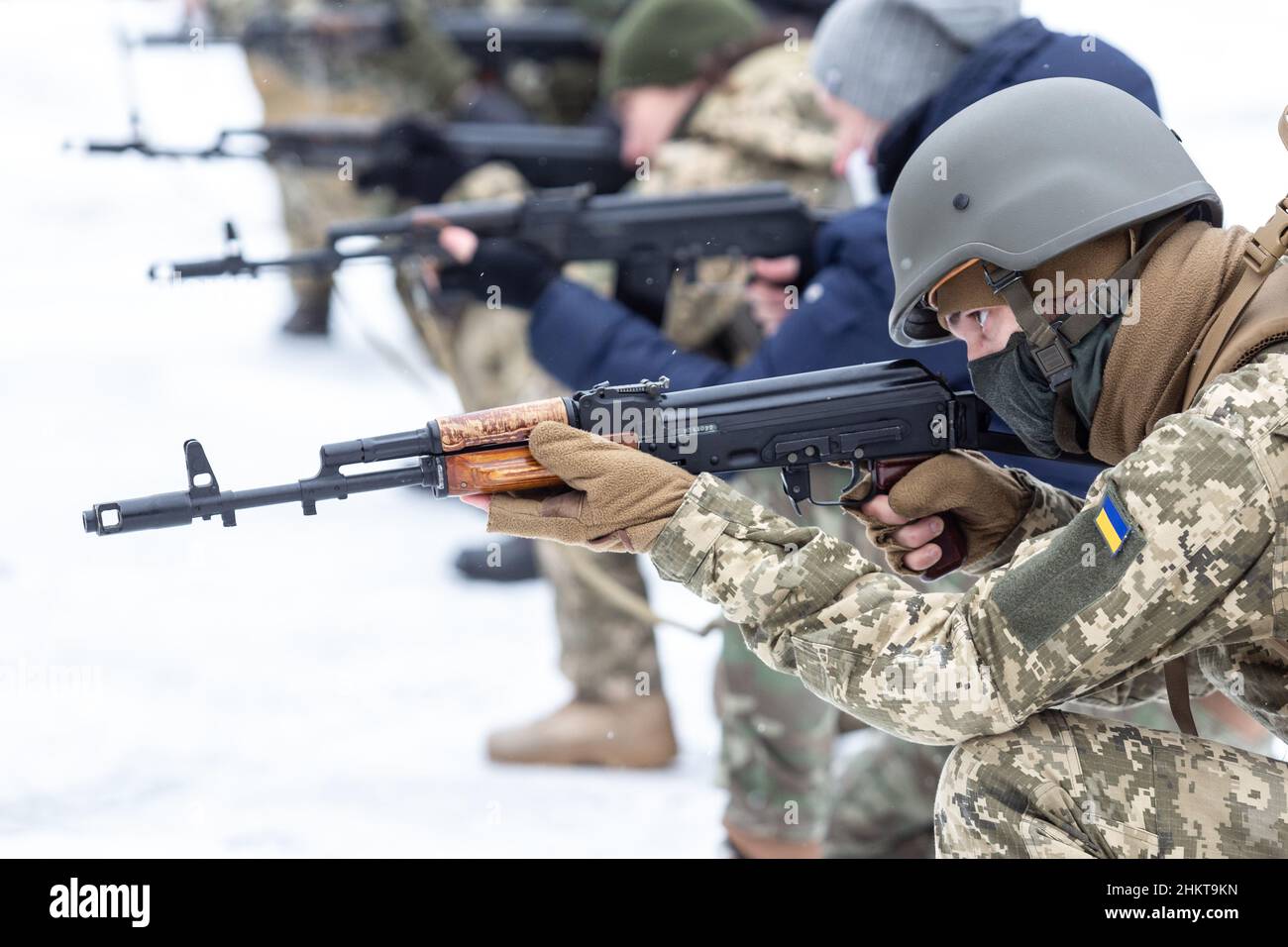 Civilians aim with rifles during a Territorial Defence Force exercise ...