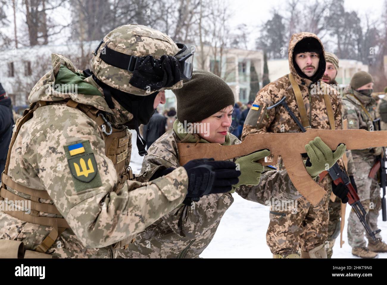 A woman taught how to hold a rifle during a Territorial Defence Force ...