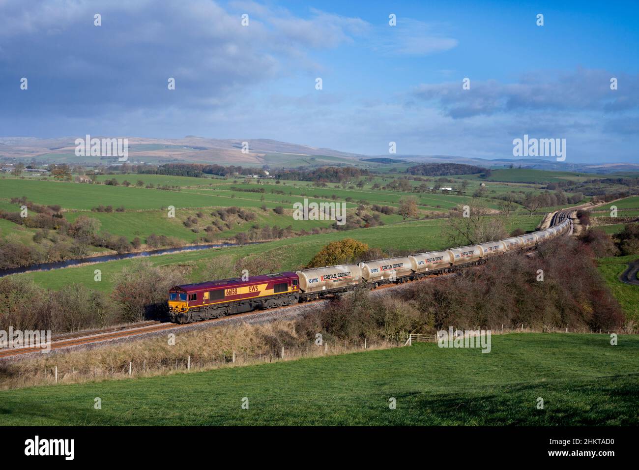 DB Schenker class 66 locomotive 66158 in EWS livery running along the ...