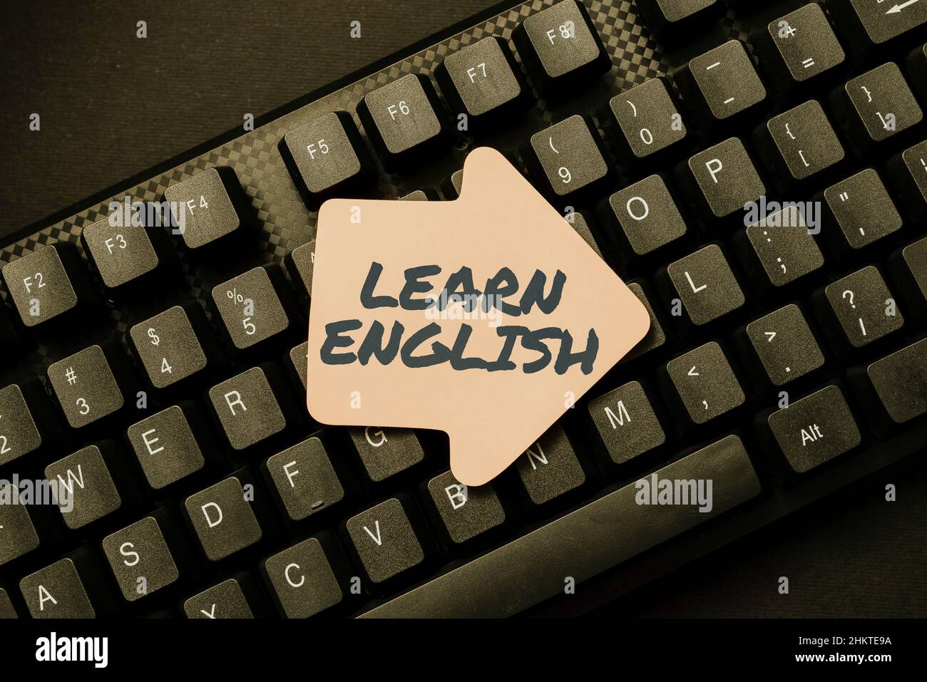 Hand writing sign Learn English. Business approach to train writing and ...