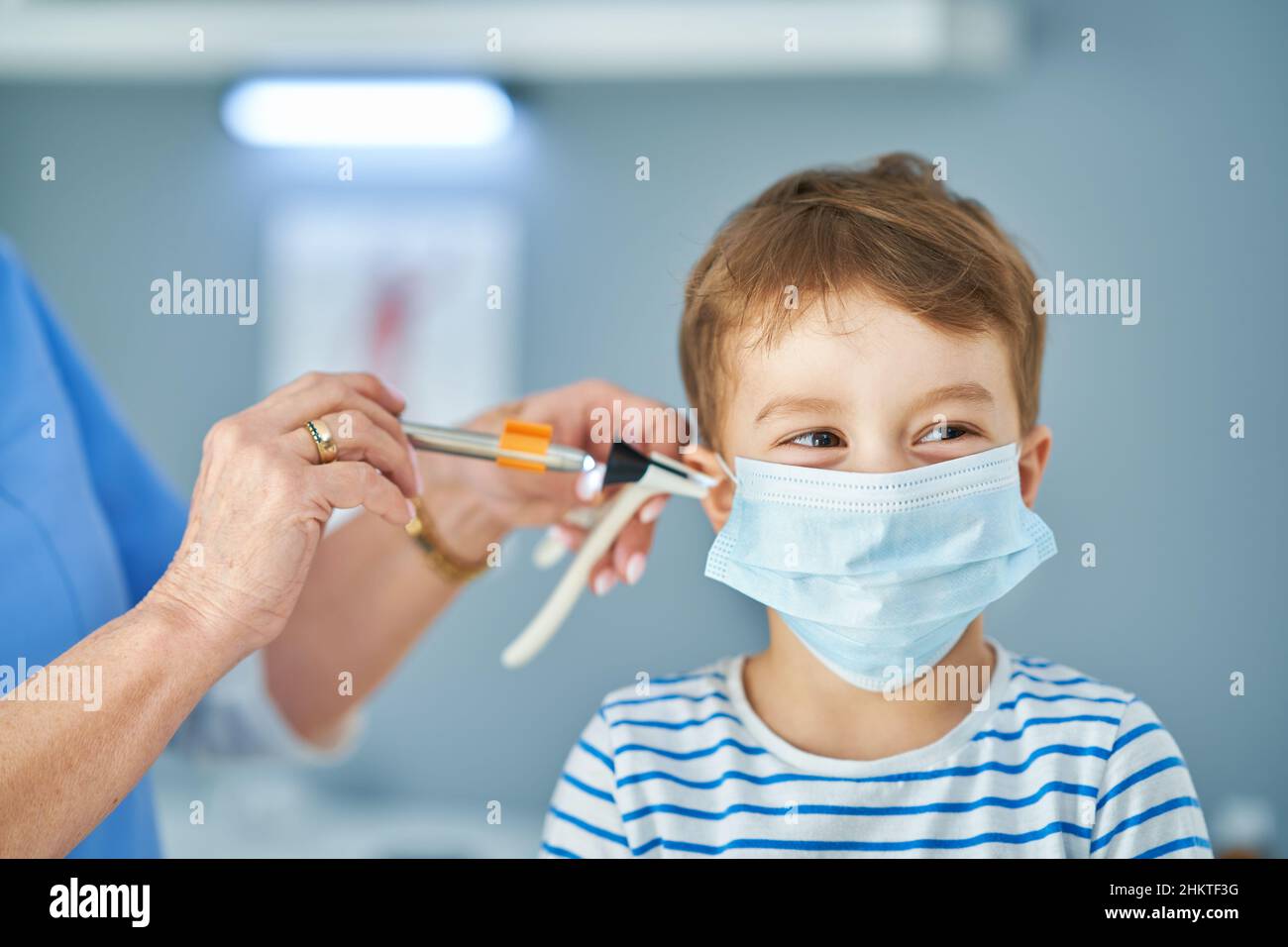 Pediatrician doctor examining little kids in clinic ears check Stock ...