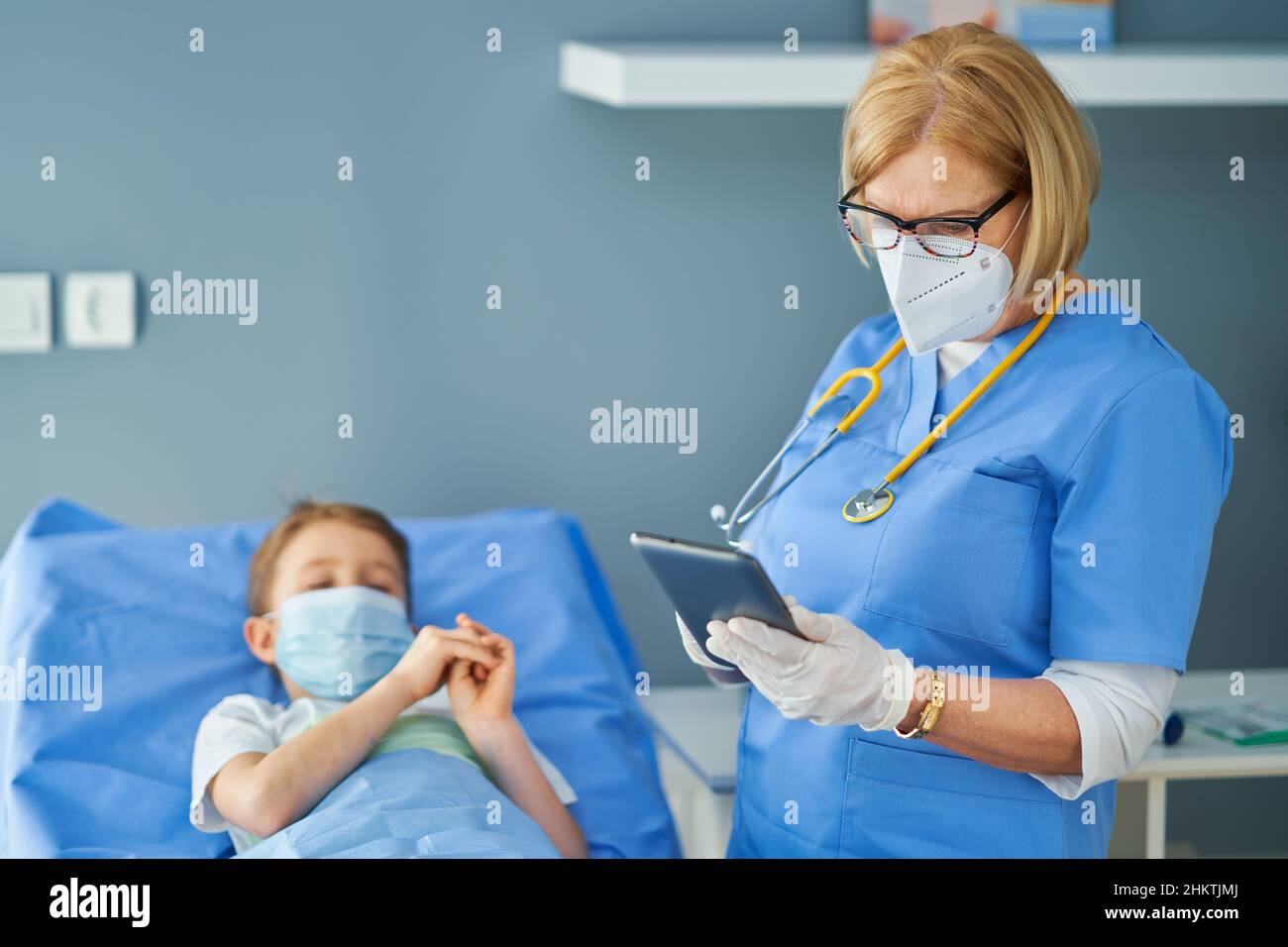 Adult woman and young patient in hospital bed Stock Photo - Alamy