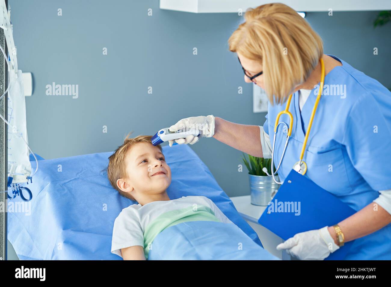 Adult woman and young patient in hospital bed Stock Photo - Alamy