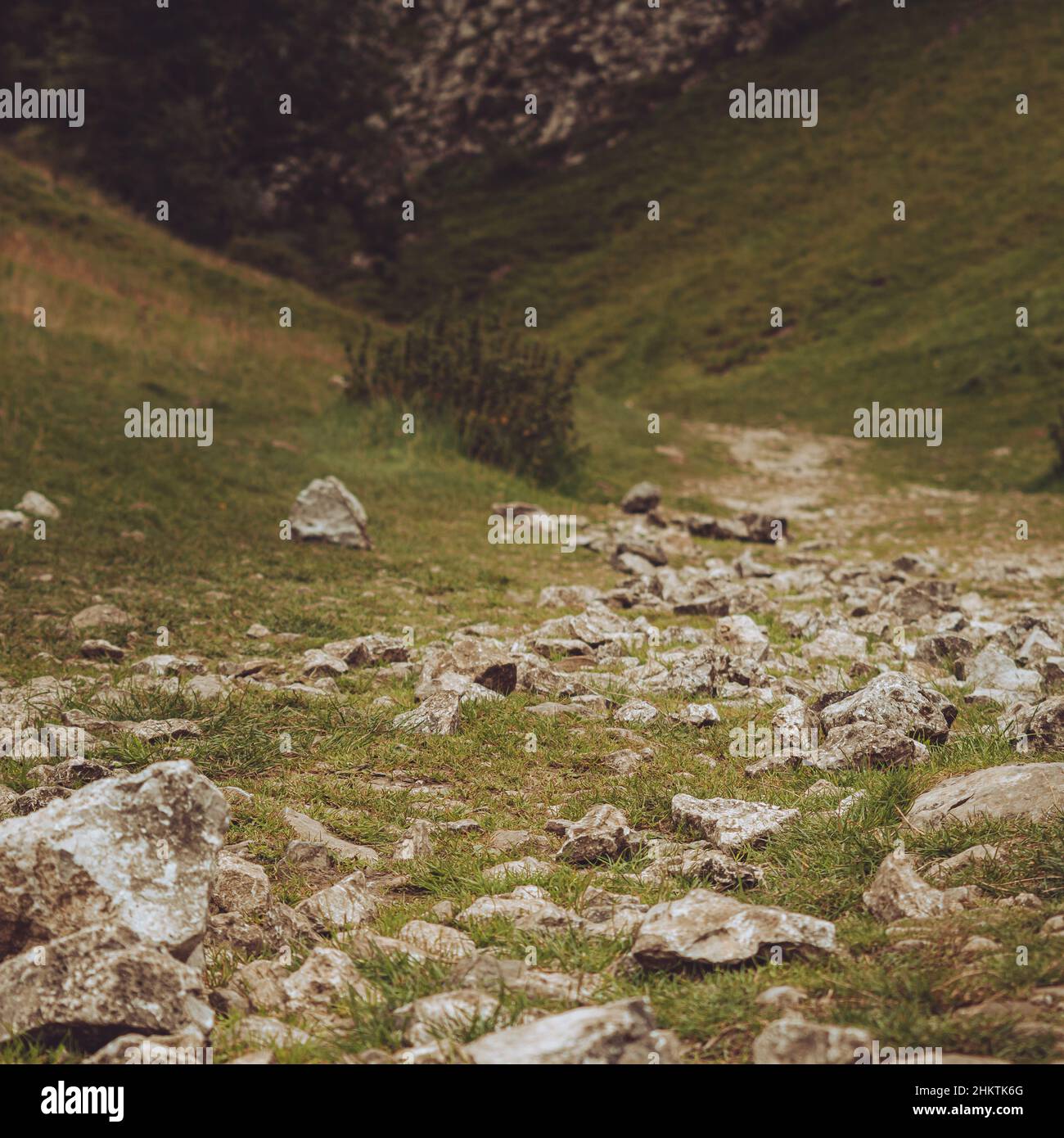 Closeup of rocks on the footpath in between hills, rocky way down in ...