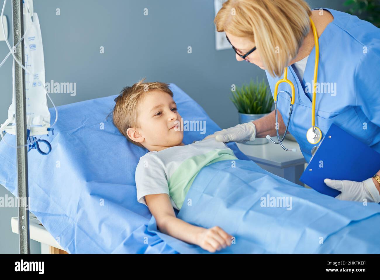 Adult woman and young patient in hospital bed Stock Photo - Alamy