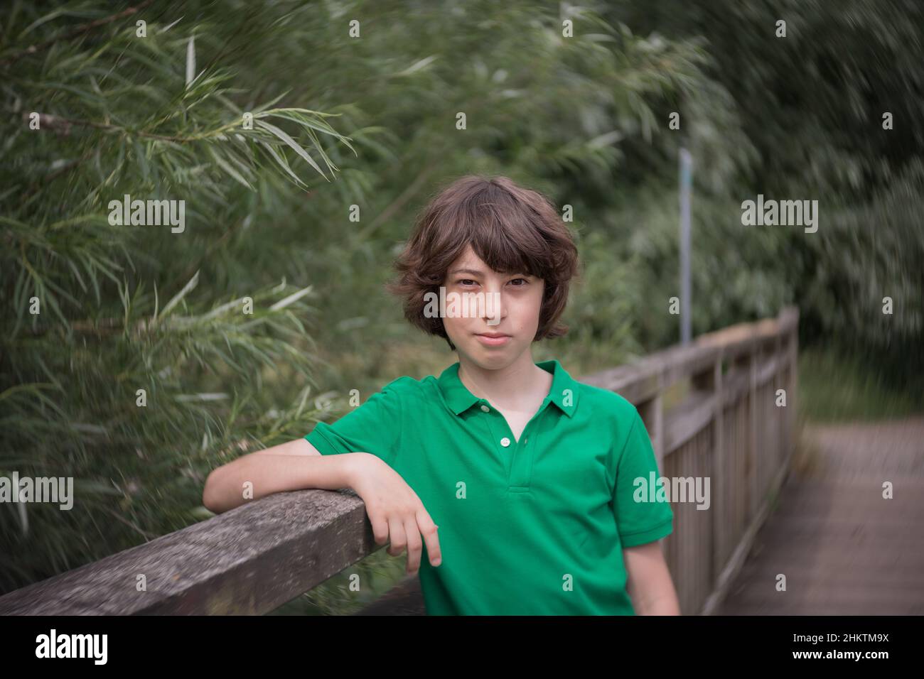 Portrait of a boy standing on a bridge Stock Photo - Alamy