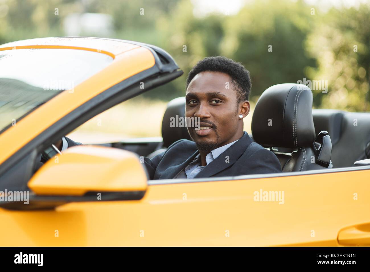 Car side window. Young handsome bearded African businessman driver ...