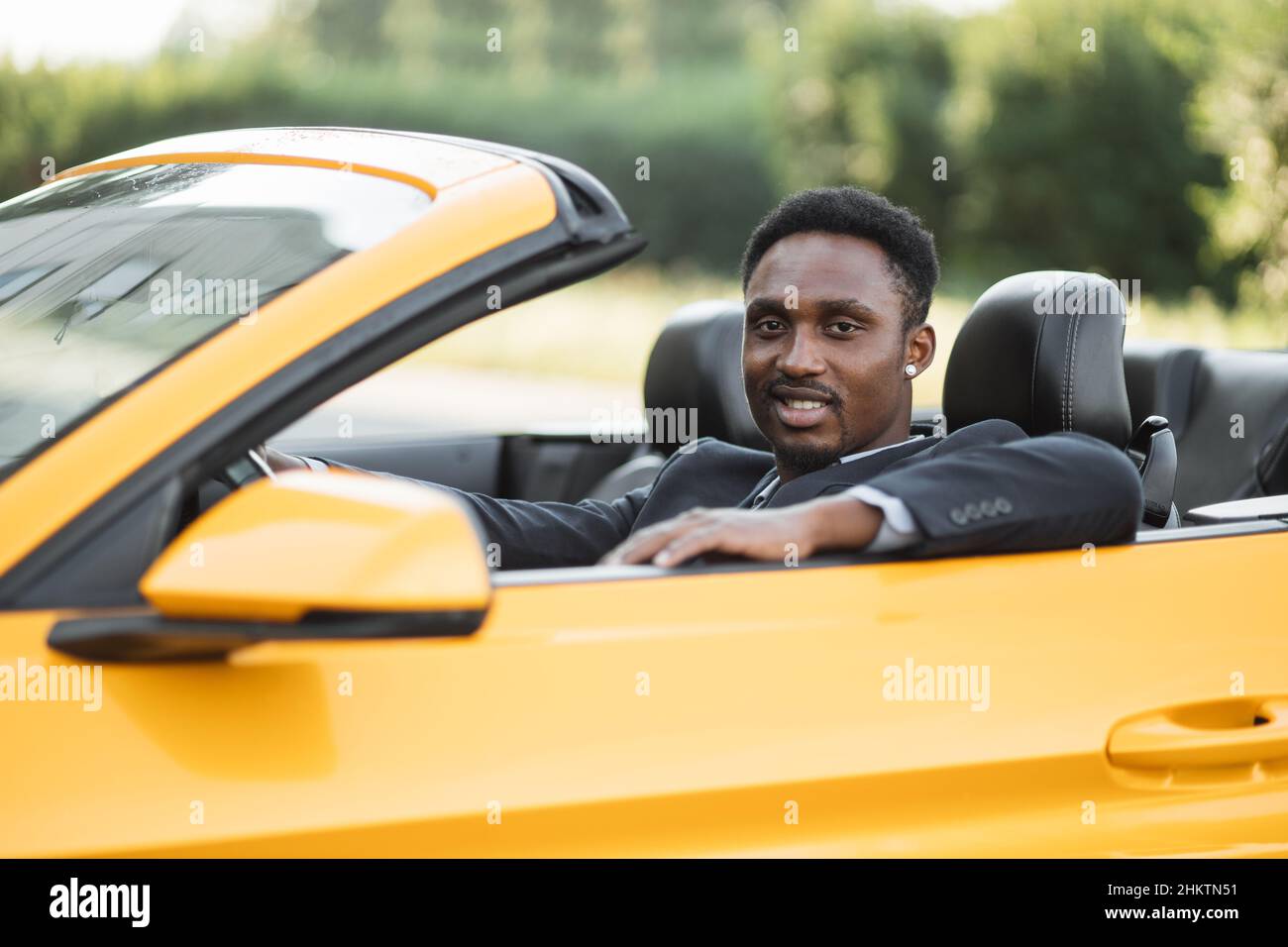 Car side window. Young handsome bearded African businessman driver ...