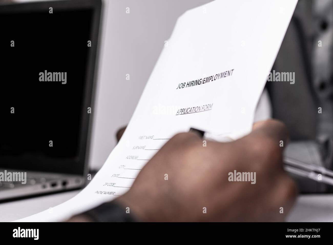 Closeup of a person holding a job application form Stock Photo - Alamy