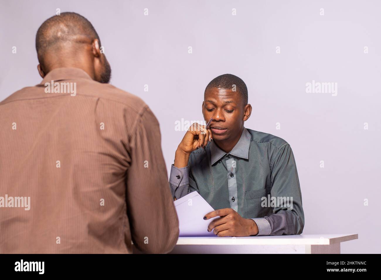 Closeup of an african man conducting a job interview Stock Photo - Alamy