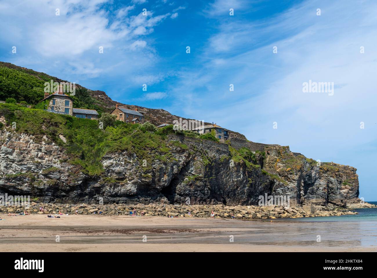 Mid summer in the beach cove,looking up at cliff tops surrounding the ...