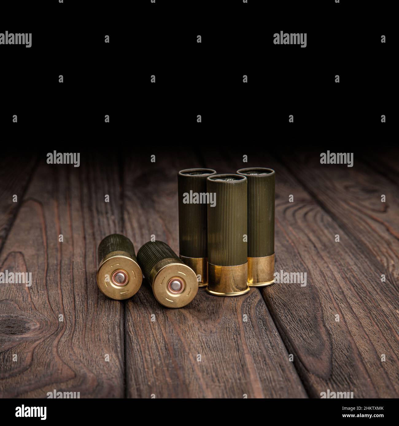 Shotgun cartridges on a brown wooden table. Ammunition for 12 gauge ...