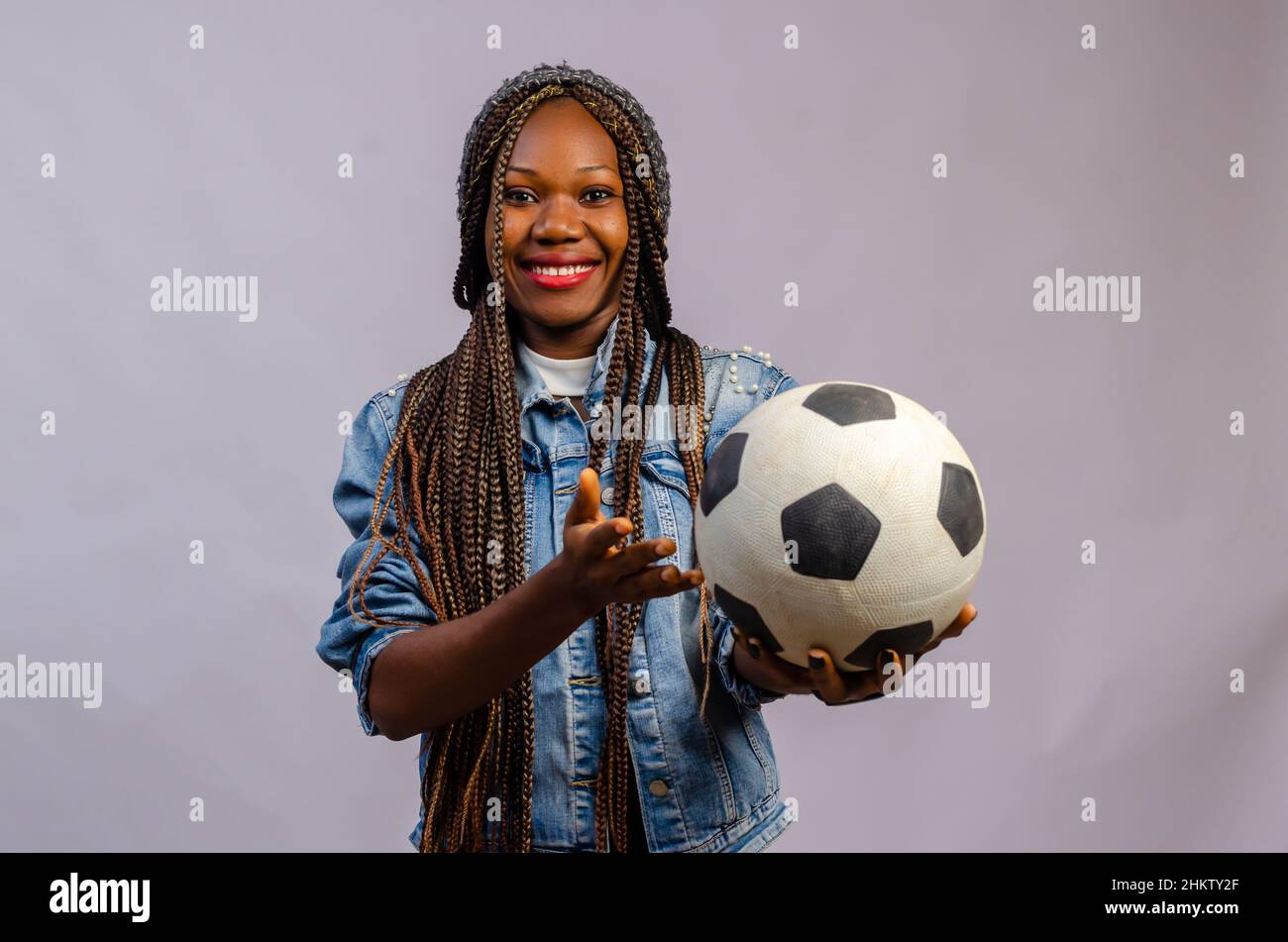 Portrait of confident female goalie pointing to ball Stock Photo - Alamy