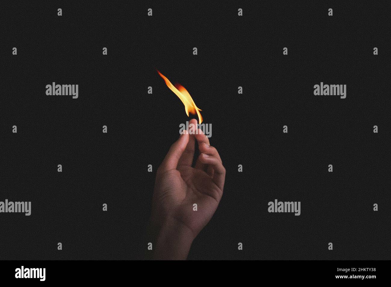 Photo of fire on fingertip isolated on a black background, sacrifice ...