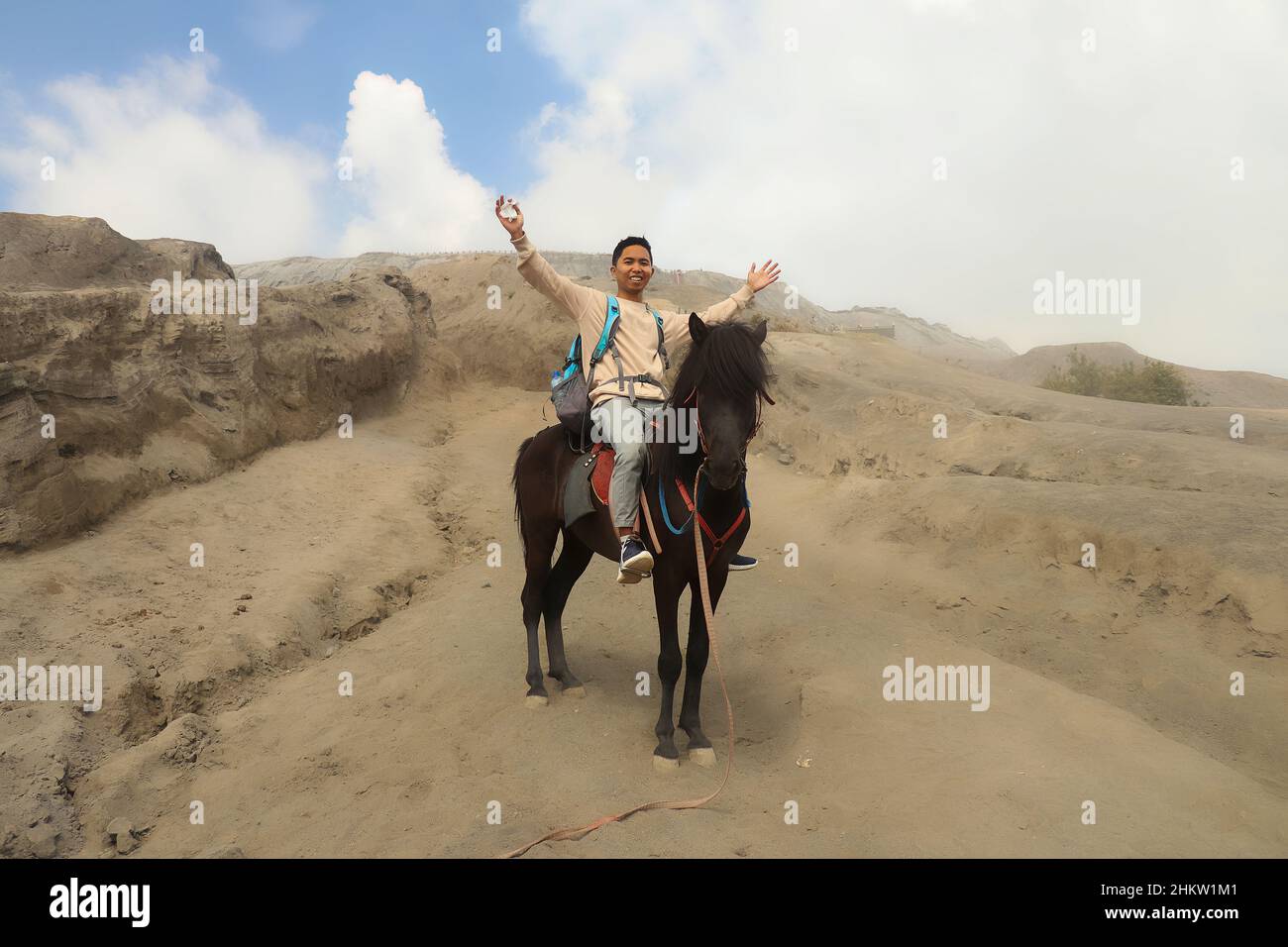 Horse riding under volcano in bromo mountain, indonesia Stock Photo - Alamy