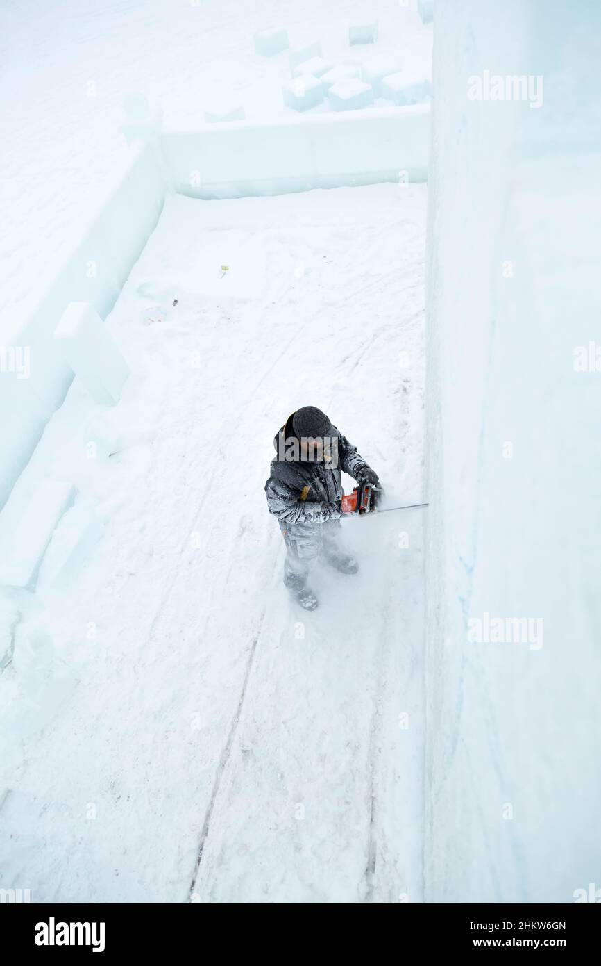 The sculptor cuts out the contours of the future composition with a ...