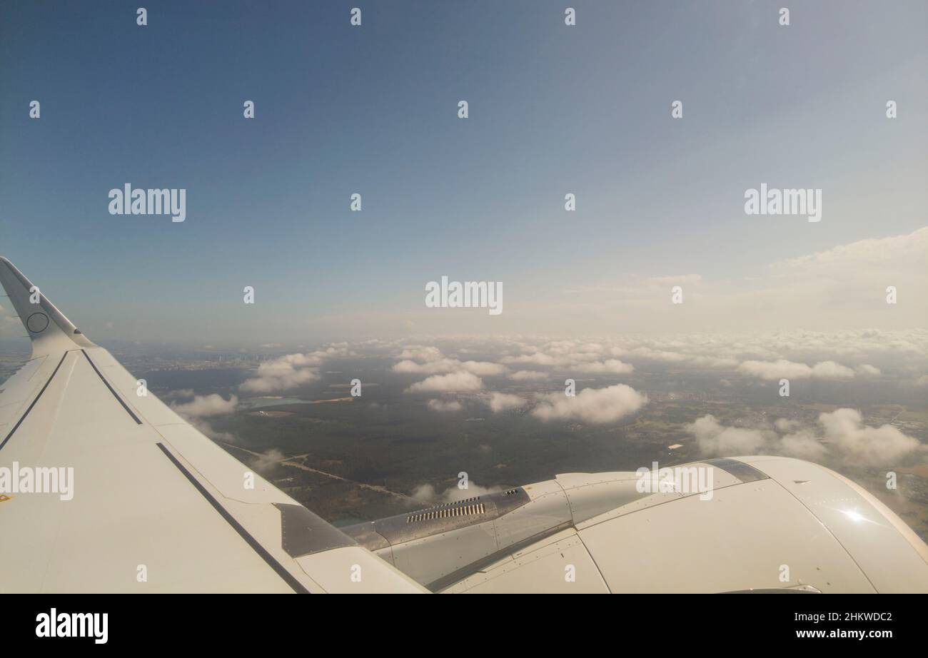 Beautiful view of aircraft wing look from cabin window. Blue sky, white ...