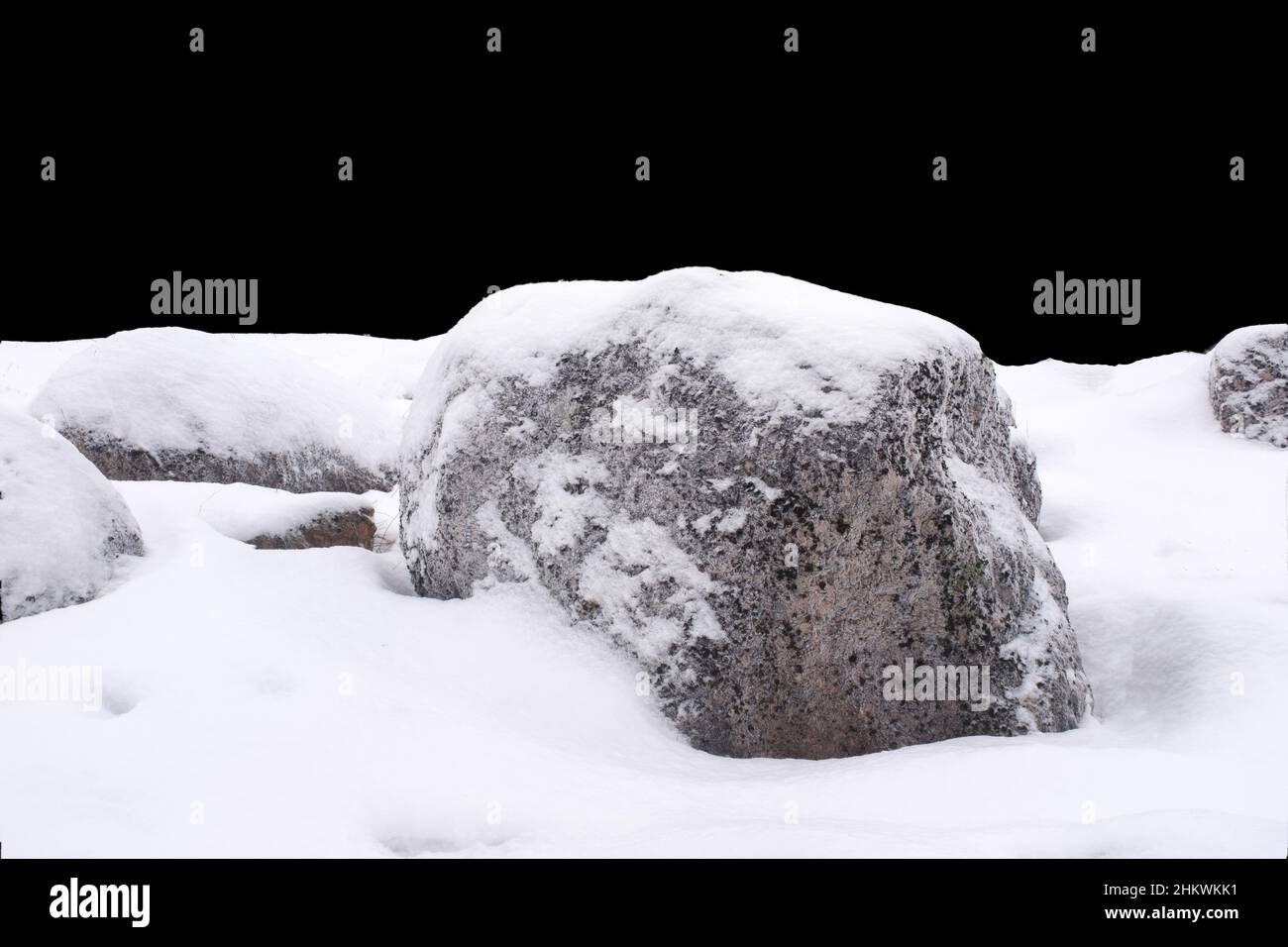 natural stone in snow isolated on black background. High quality photo ...