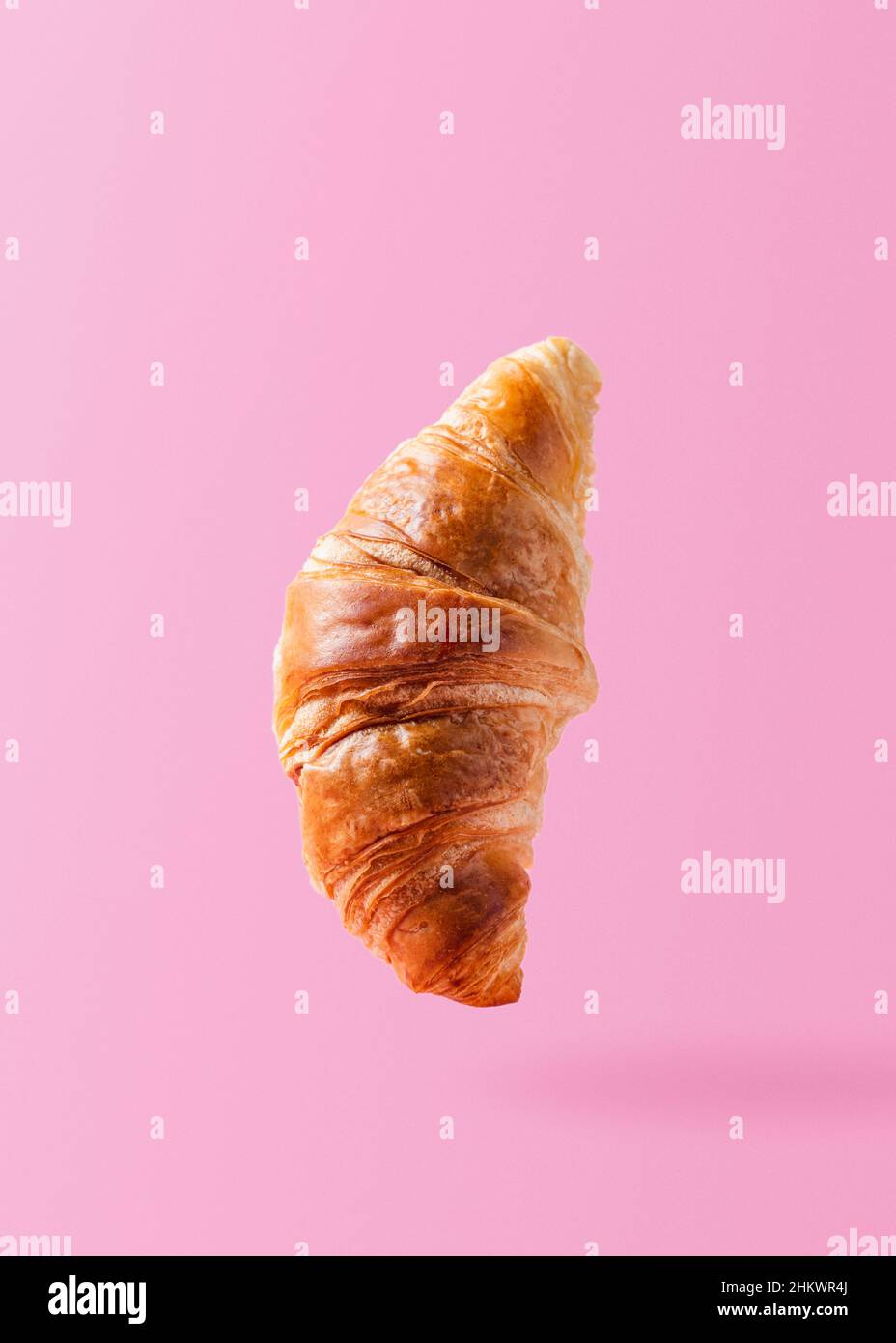 Freshly baked croissant levitating or flying. Croissant fly in the air ...