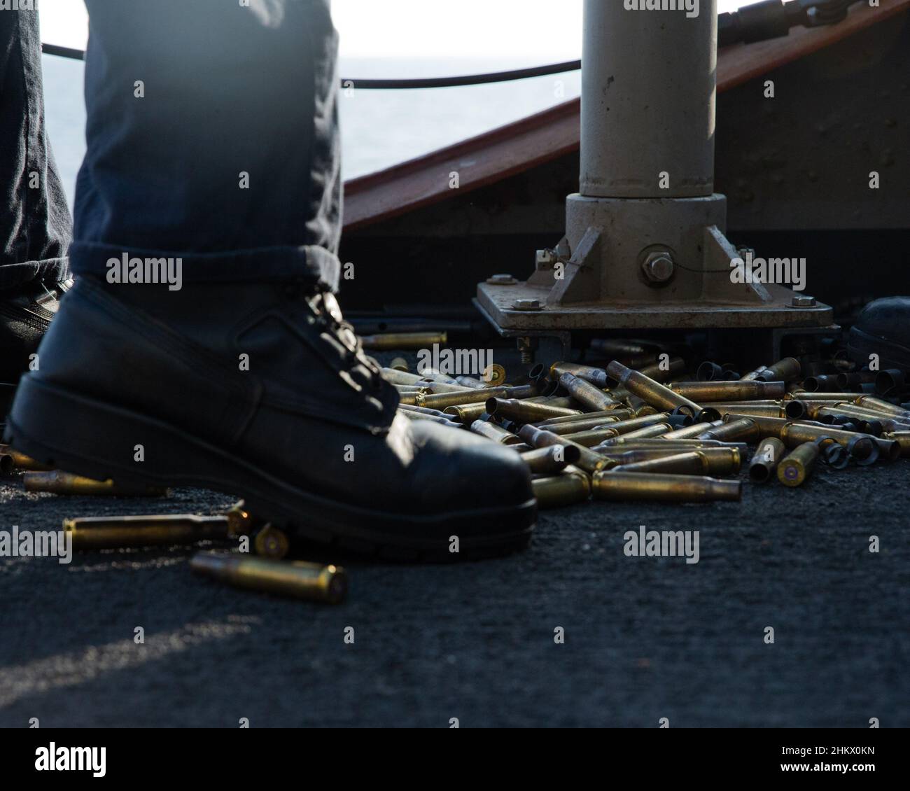 .50 caliber casings lay on the weather deck during a live fire exercise ...