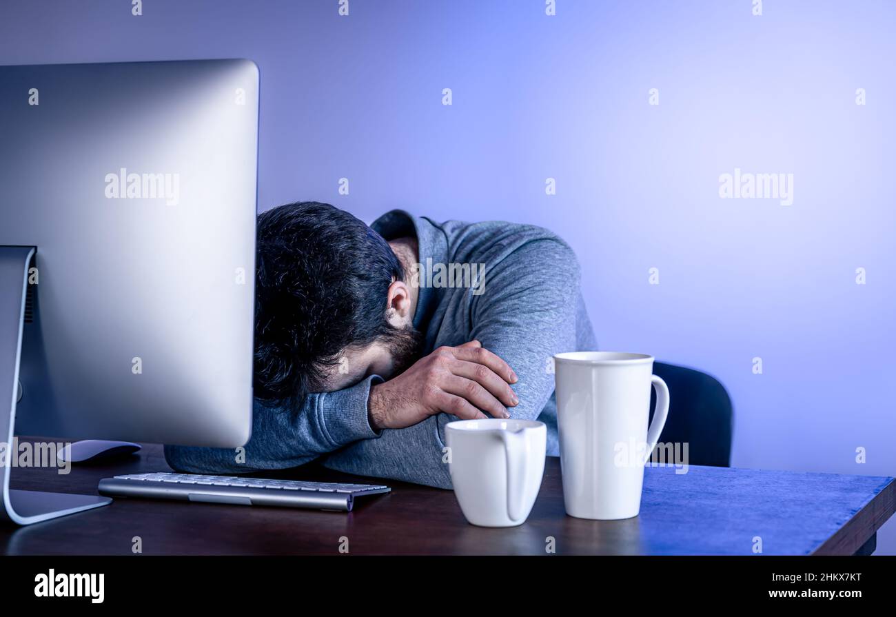 Tired man sleeping in front of the computer, fatigue concept, night ...