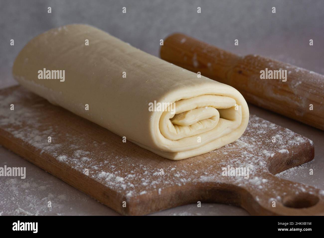 Rolled raw homemade puff pastry on the kitchen board Stock Photo - Alamy