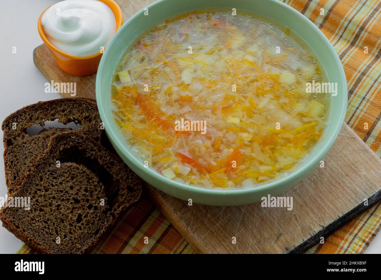 Traditional soup of Russia Shchi served with sour cream as garnish ans ...