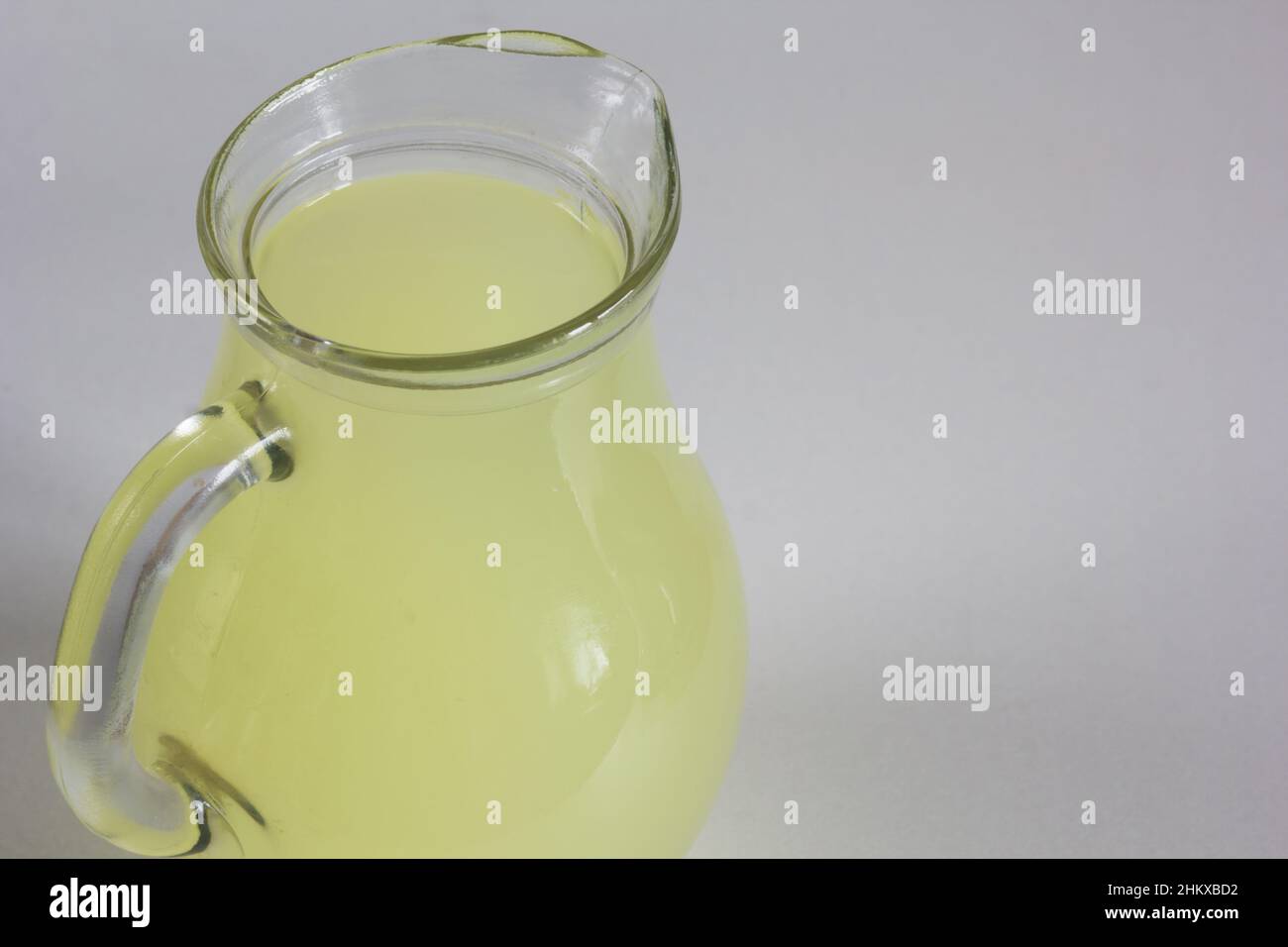 Liquid whey that remains after formation of curds in jar on the white ...