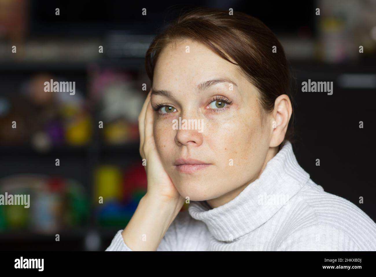 Portrait of middle aged caucasian woman with calm look holding her ...
