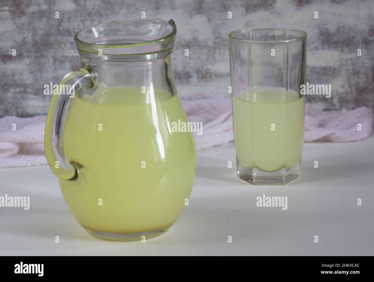 Jar and glass with liquid whey that remains after formation of curds on ...