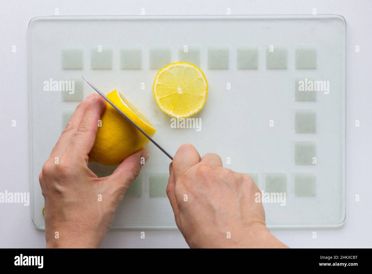 Woman hand slices lemon hi-res stock photography and images - Alamy