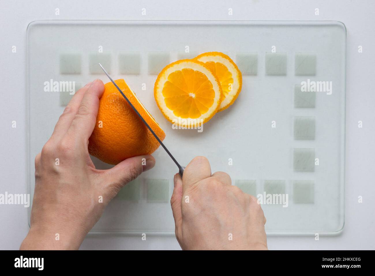 Woman cut orange hi-res stock photography and images - Alamy