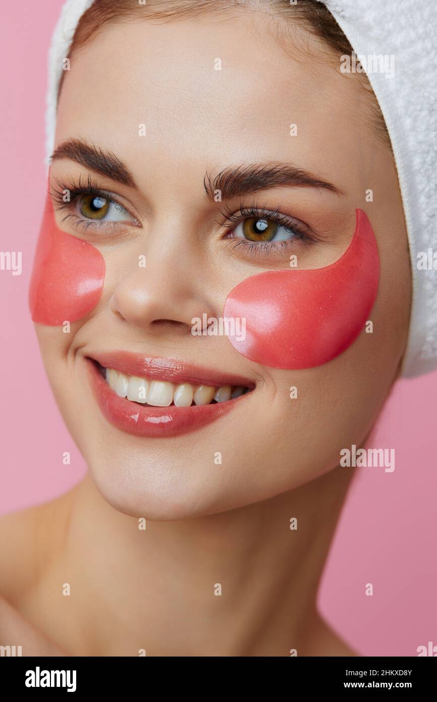 portrait woman pink patches on the face with a towel on the head ...