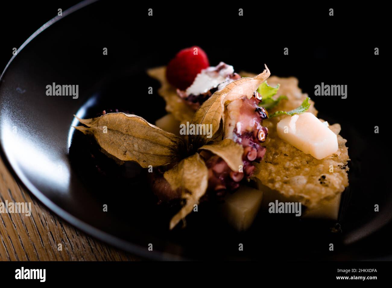 Serving of dessert with octopus tentacles in a fish market in Italy ...