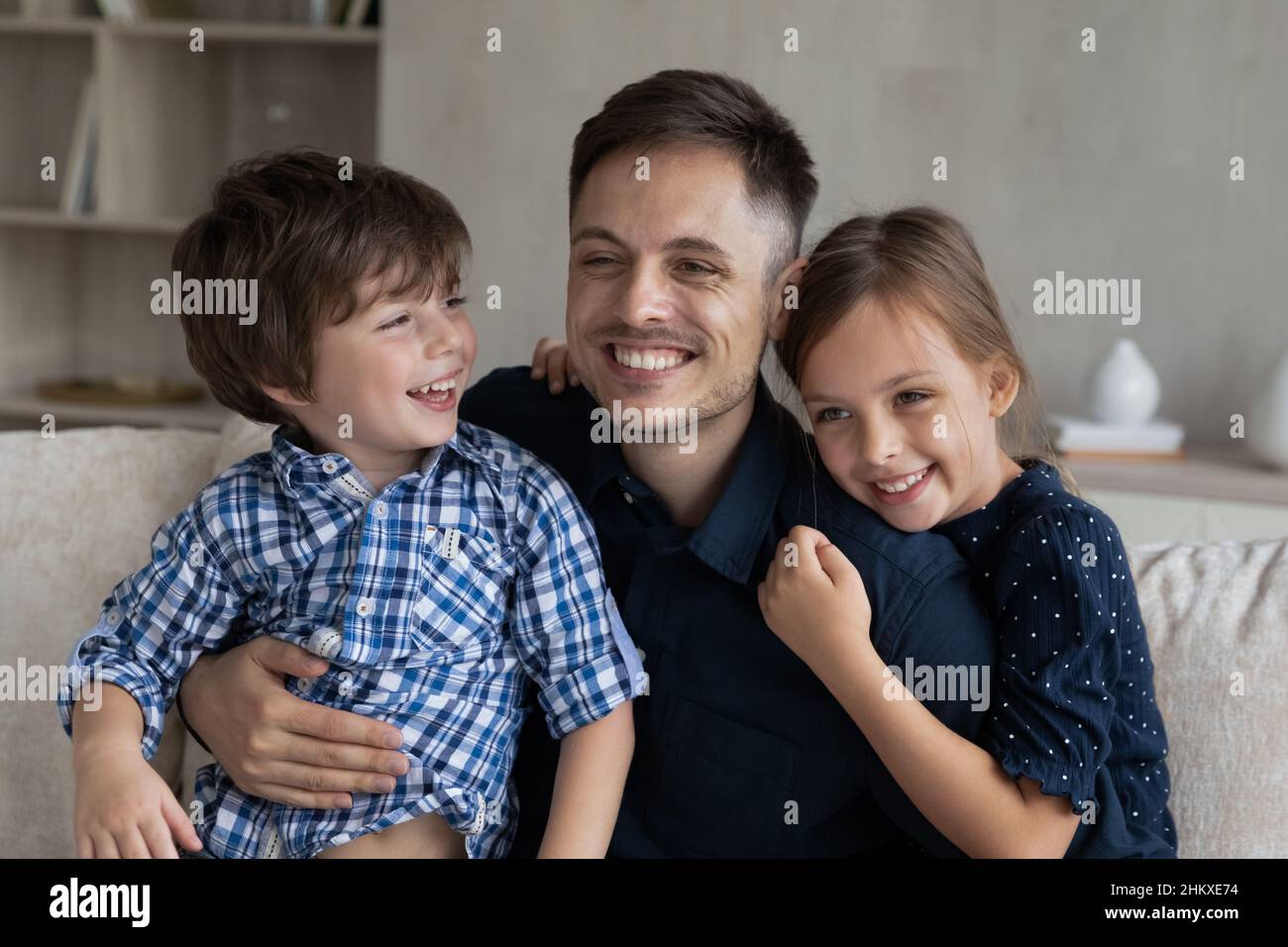 Kids hugging father hi-res stock photography and images - Alamy