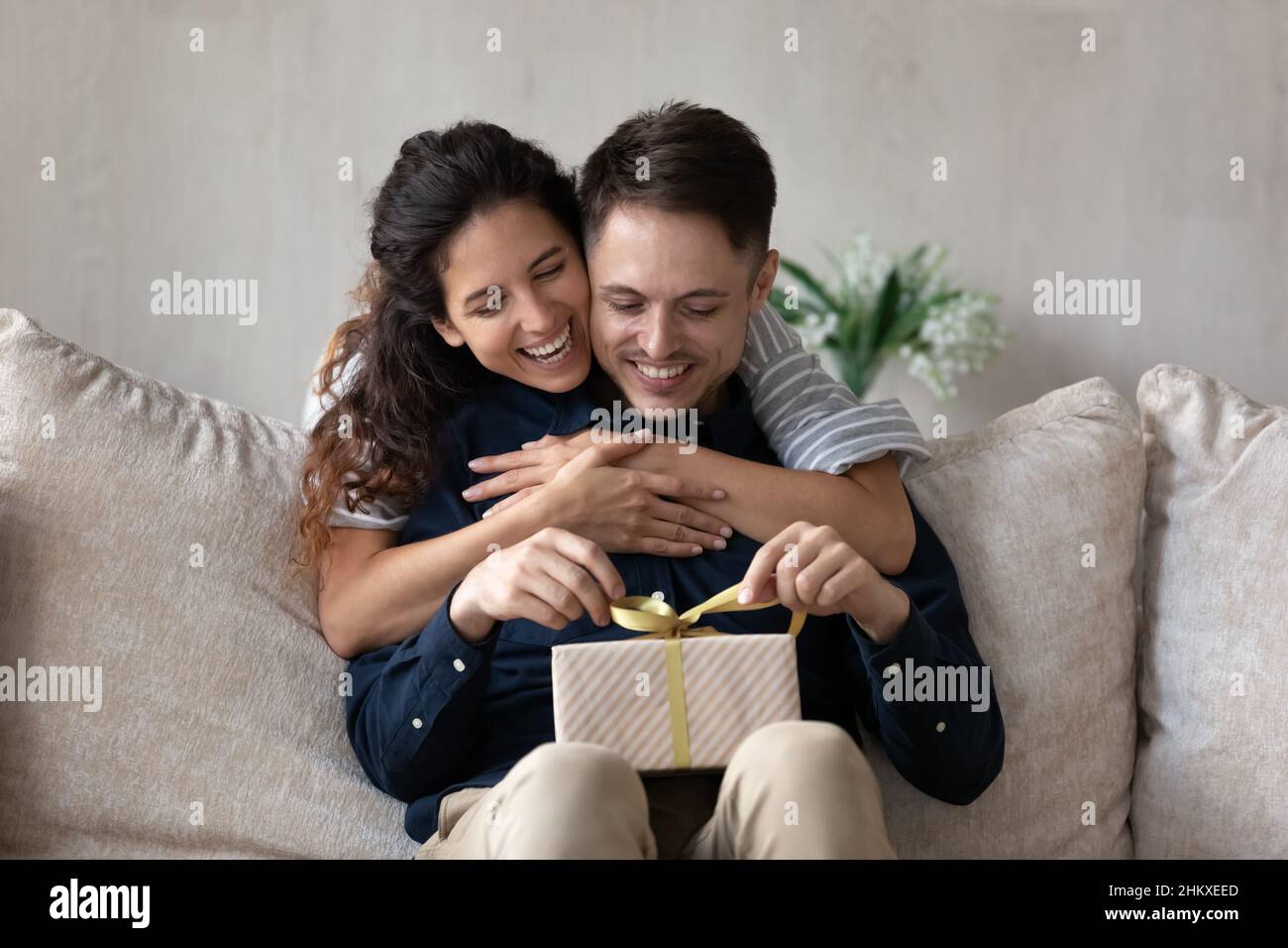 Loving girlfriend congratulating boyfriend, hugging from back ...
